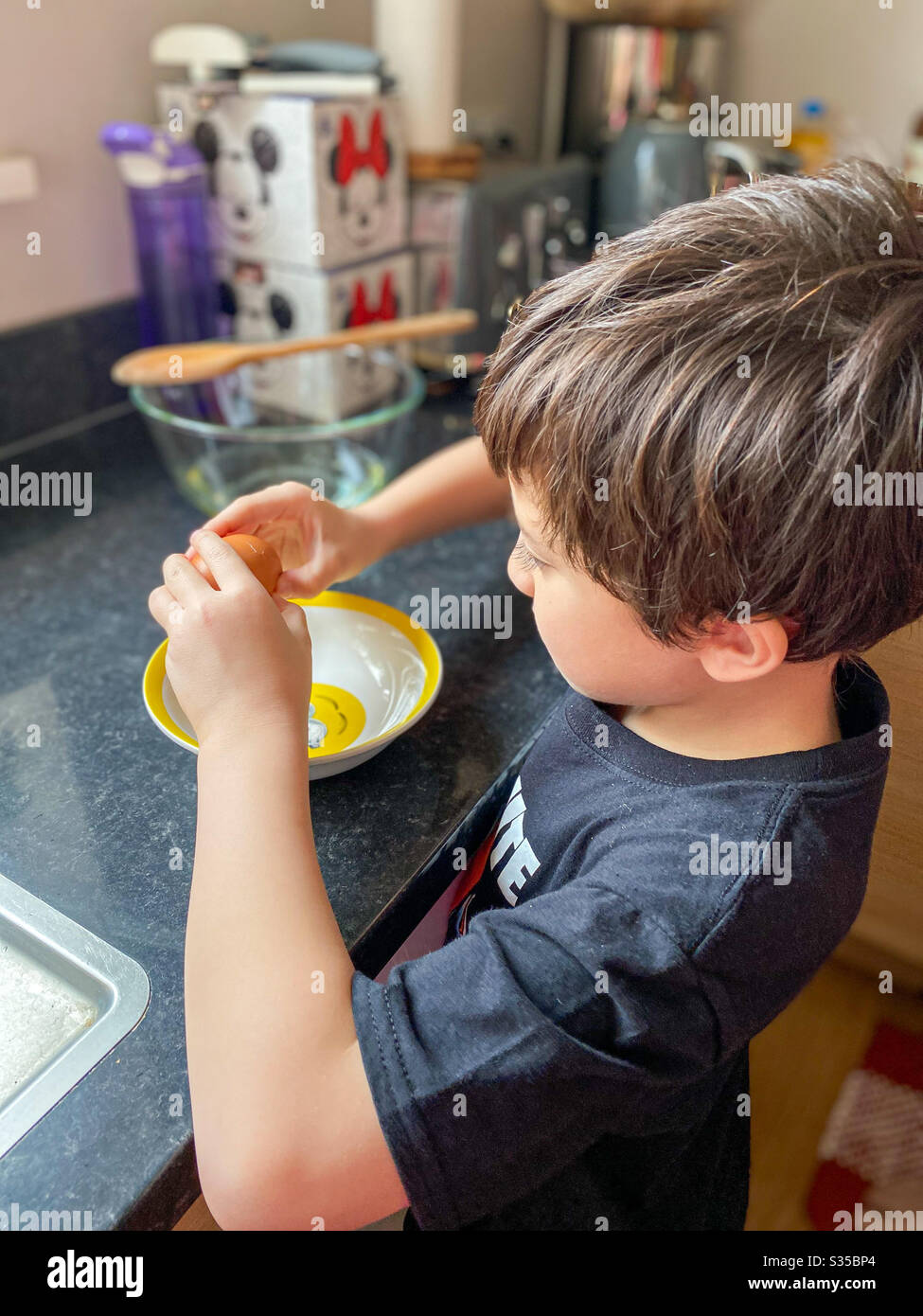 Child cracking egg hi-res stock photography and images - Alamy