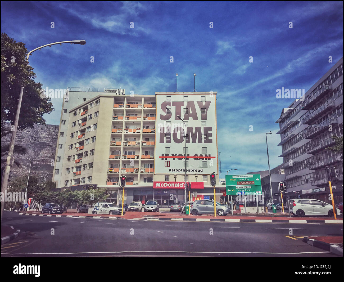 Banner on apartment block reminding Capetonians to stay home during ...