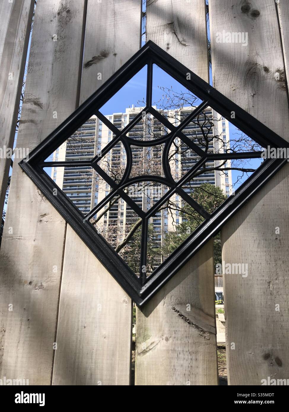 Peeking through the window of a wooden fence Stock Photo - Alamy