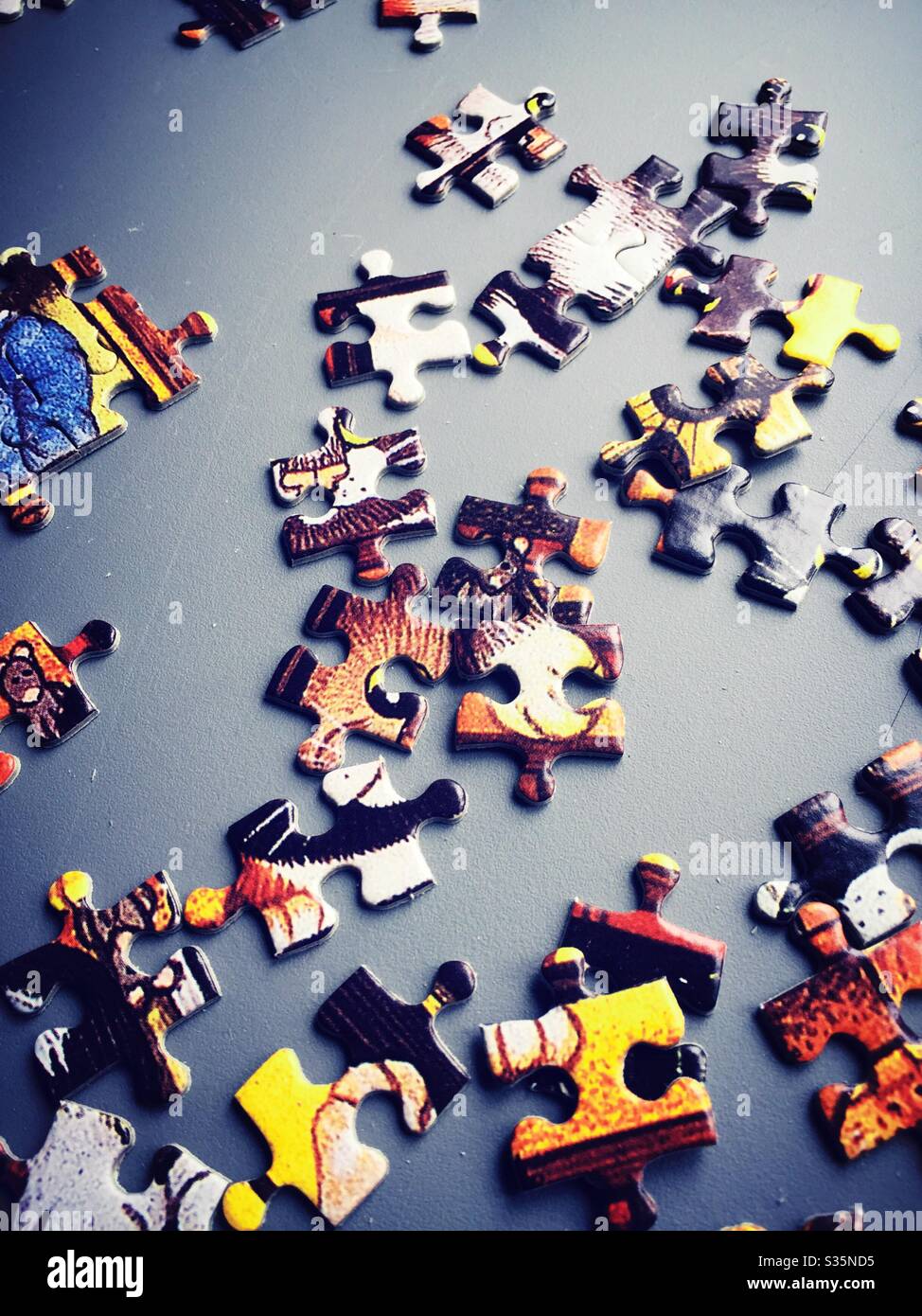 Still life of interlocking puzzle pieces in the process of assembly ...