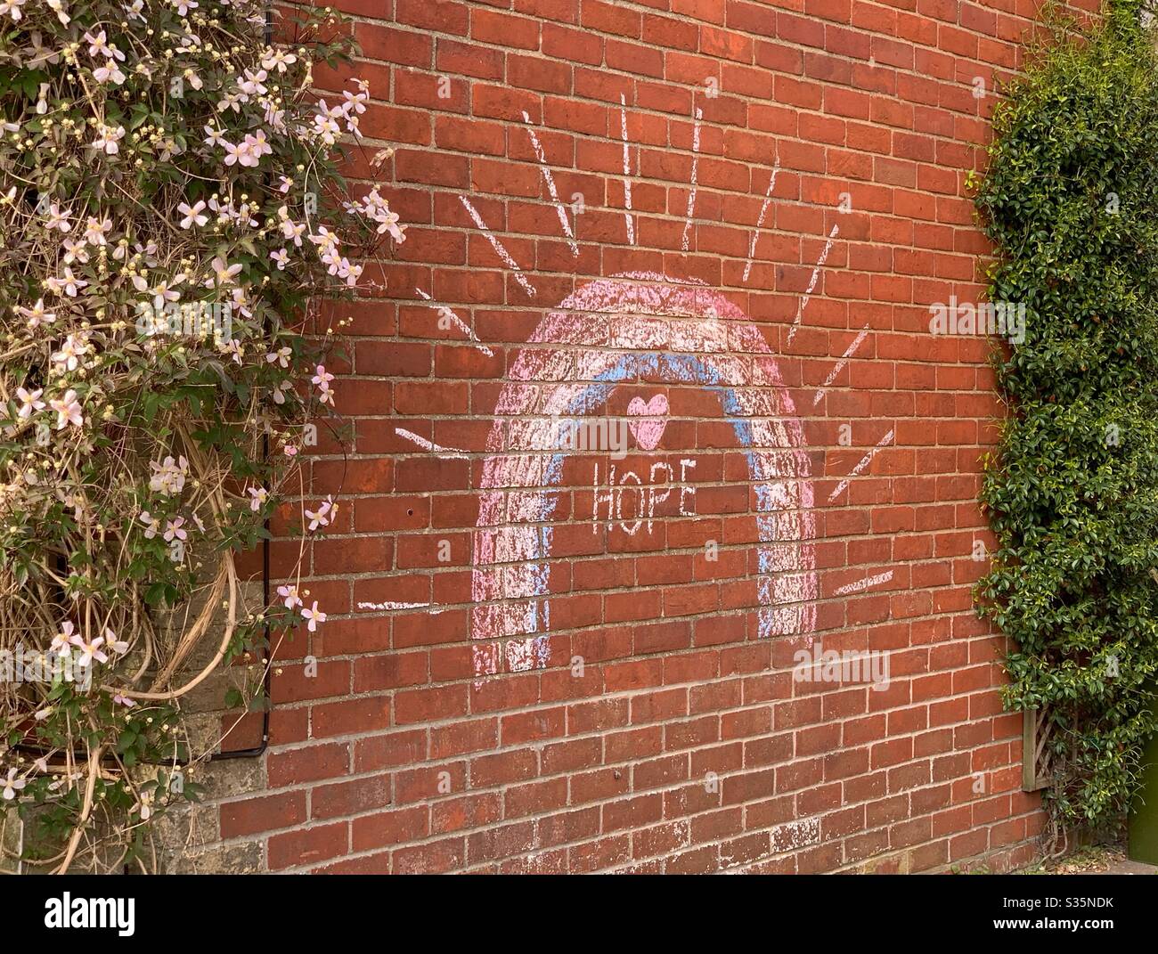 Rainbow message of hope on wall of house Stock Photo - Alamy
