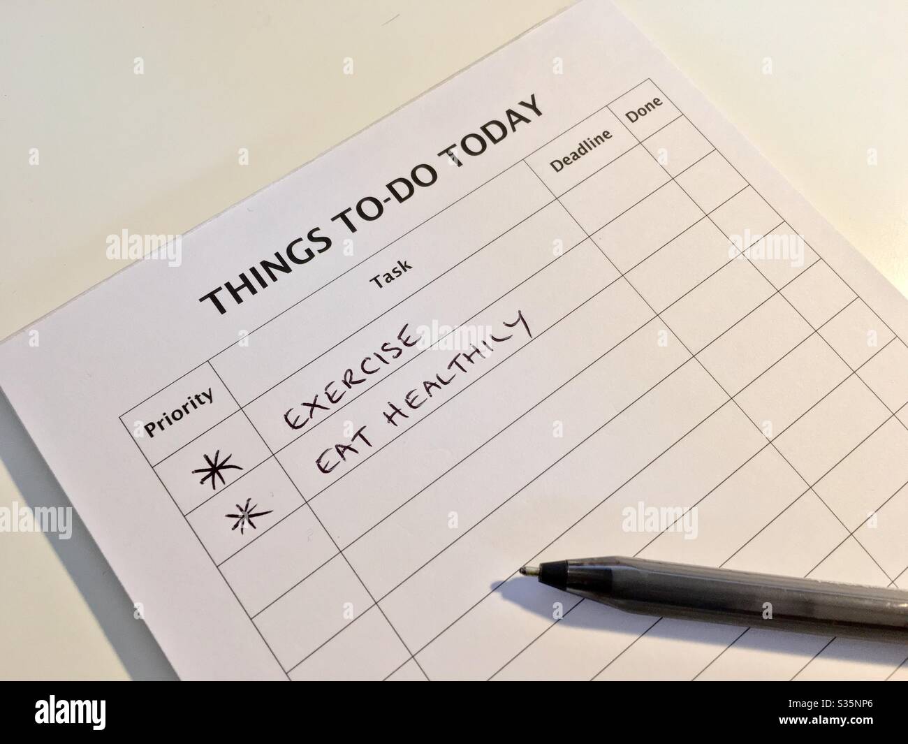 A photograph of a to-do list, with tasks including ‘exercise’ and ‘eat ...