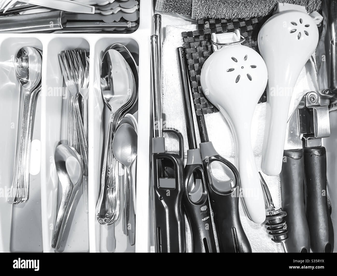 Kitchen drawer with utensils, lighter, lemon squeezer in black and ...