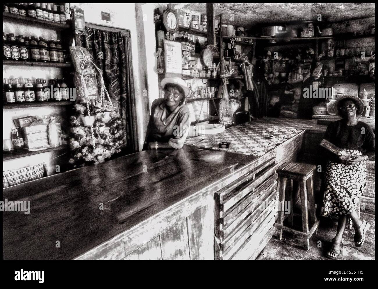 Two Jamaican women sitting inside a rural store. Westmoreland, Jamaica ...