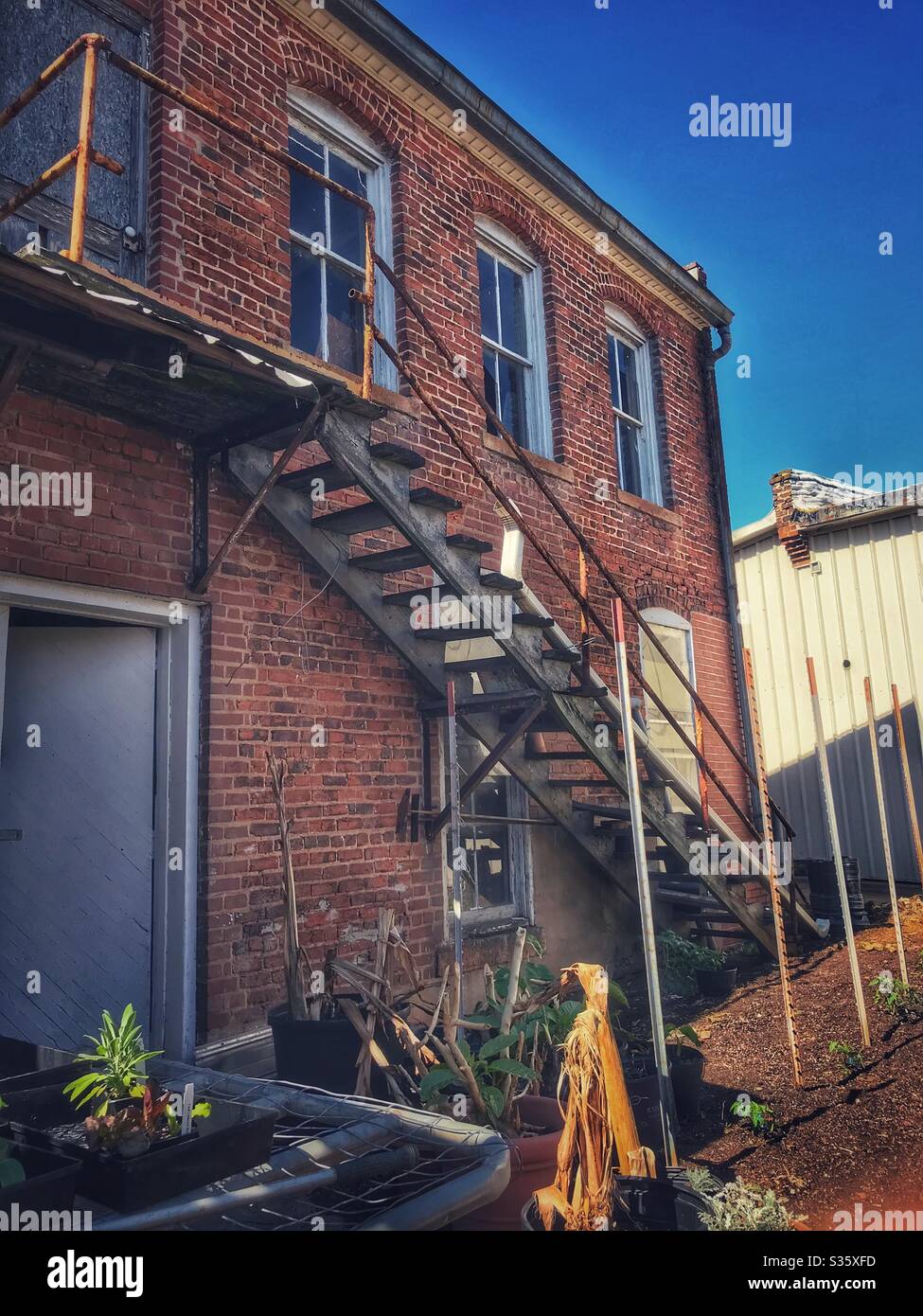 Farm supply store- old brick shop- as seen from garden section in back ...