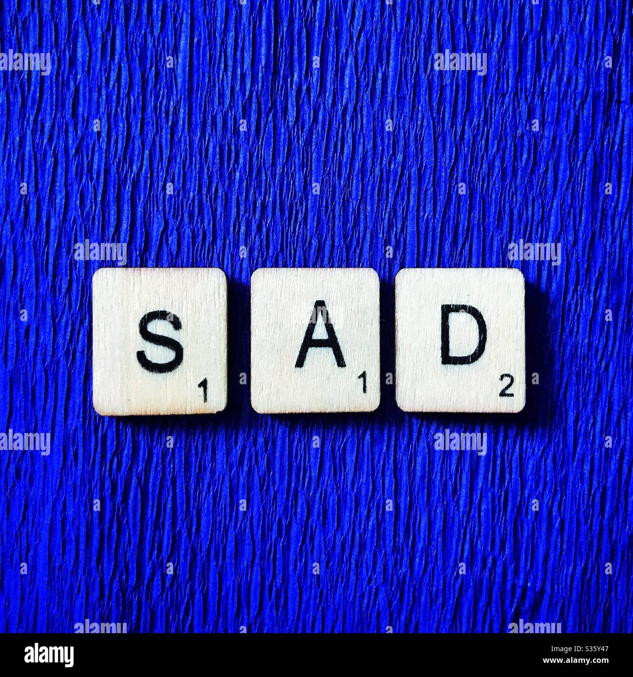 Wooden tiles spell out Sad Stock Photo - Alamy