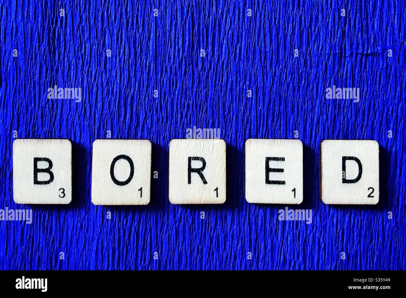 Wooden tiles spell out bored Stock Photo - Alamy