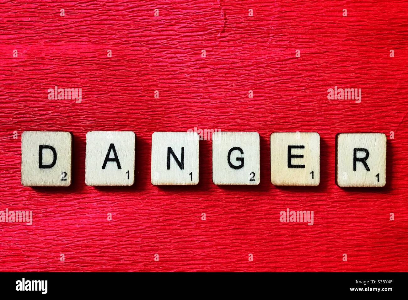 Wooden tiles spell out Danger Stock Photo - Alamy