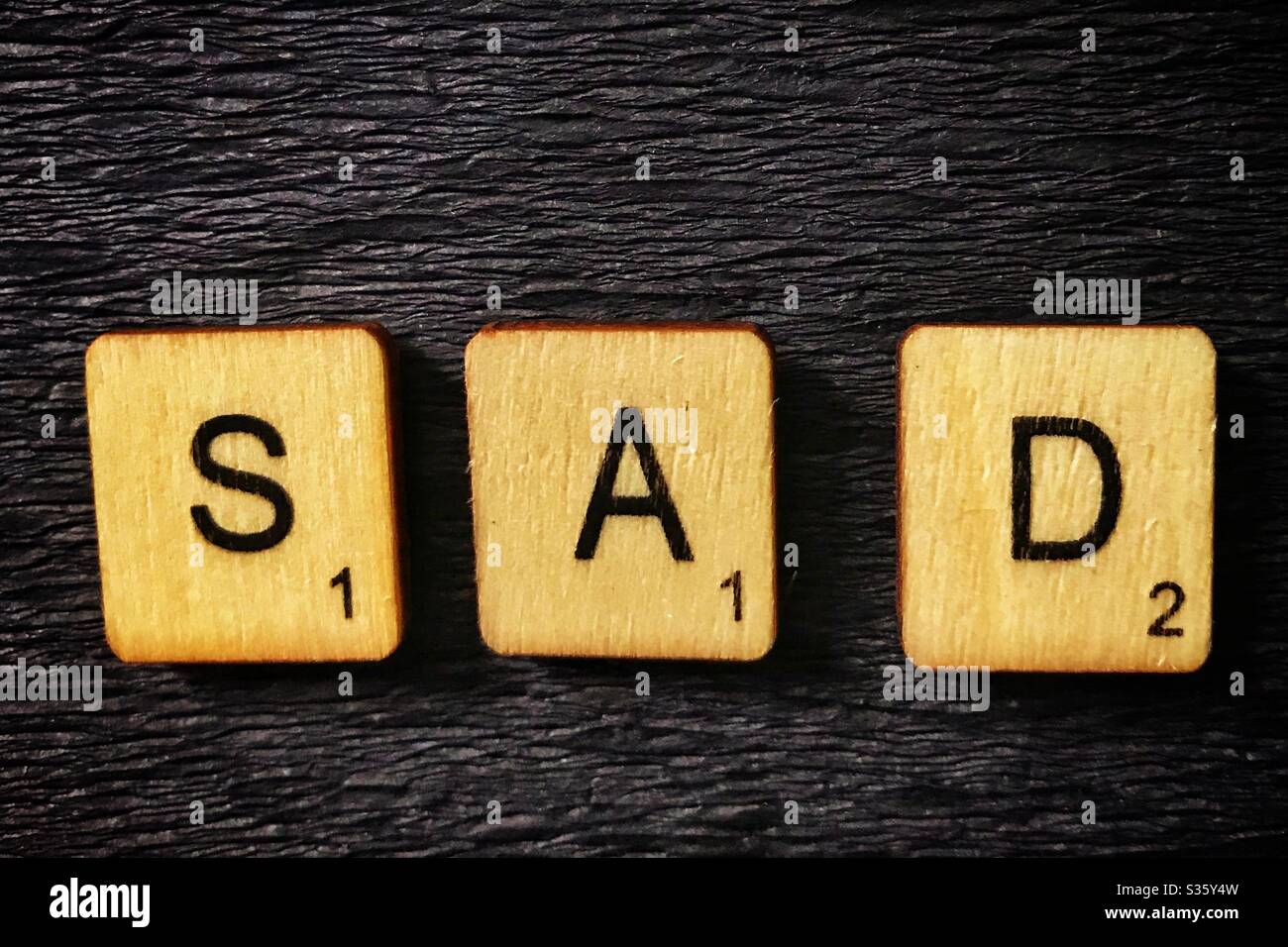 Wooden tiles spell out Sad Stock Photo - Alamy