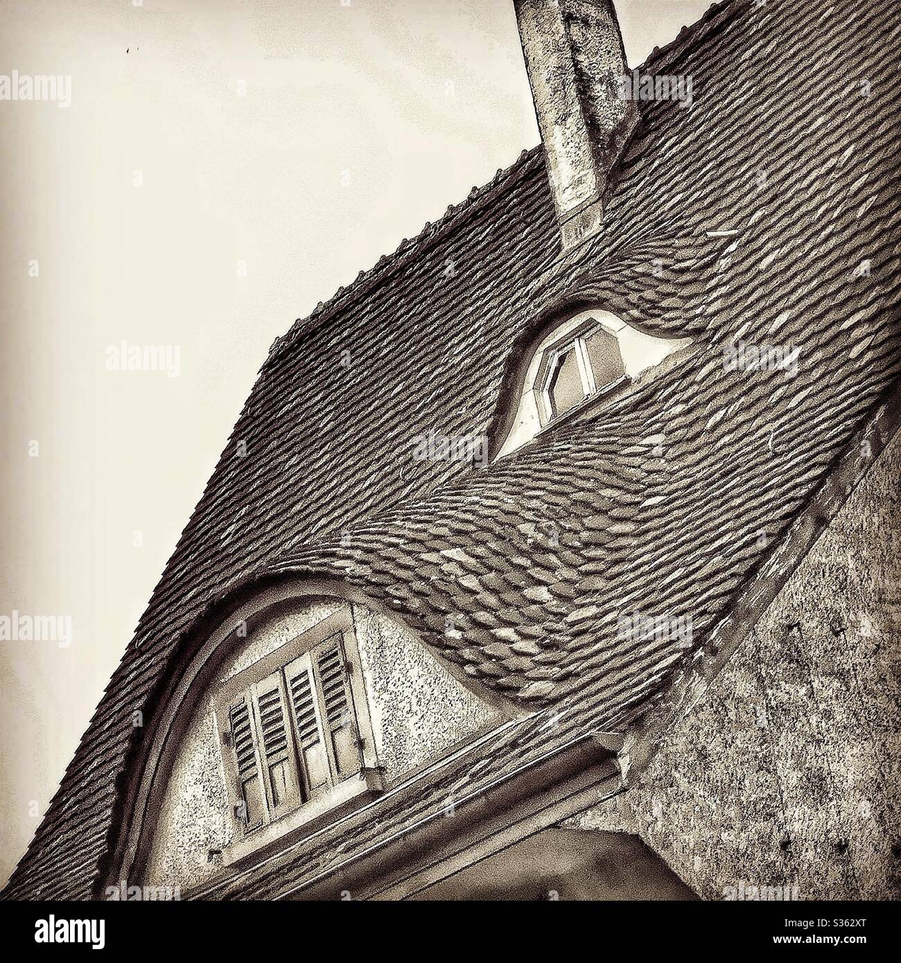 Sinuous tiled roof of Swiss house from the 1920s Stock Photo - Alamy