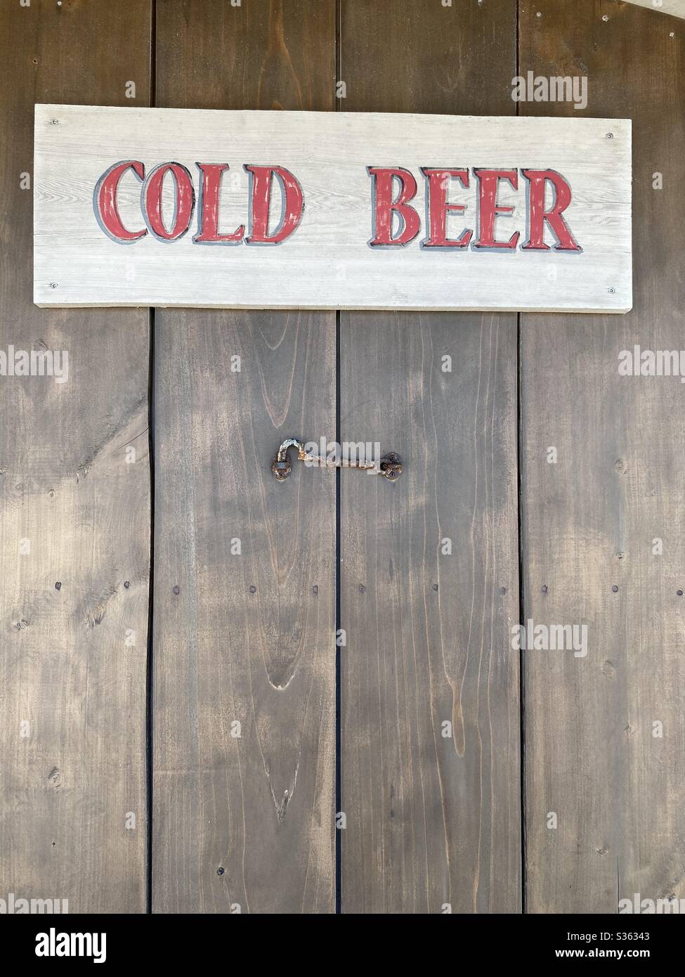 Cold beer sign on an outdoor wooden door Stock Photo - Alamy