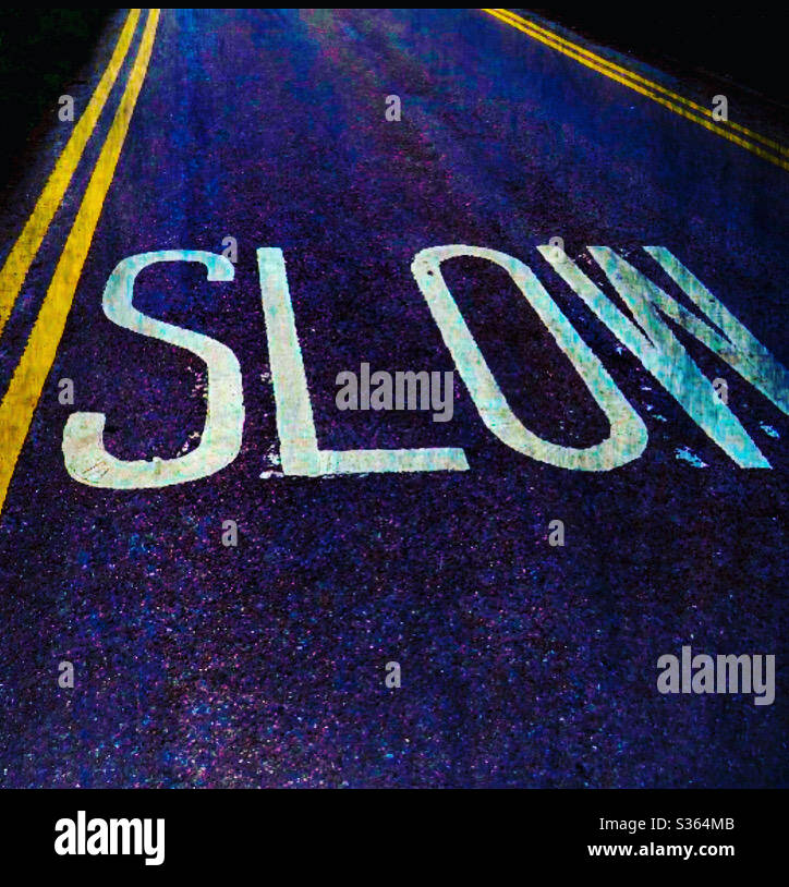 Slow road markings hi-res stock photography and images - Alamy