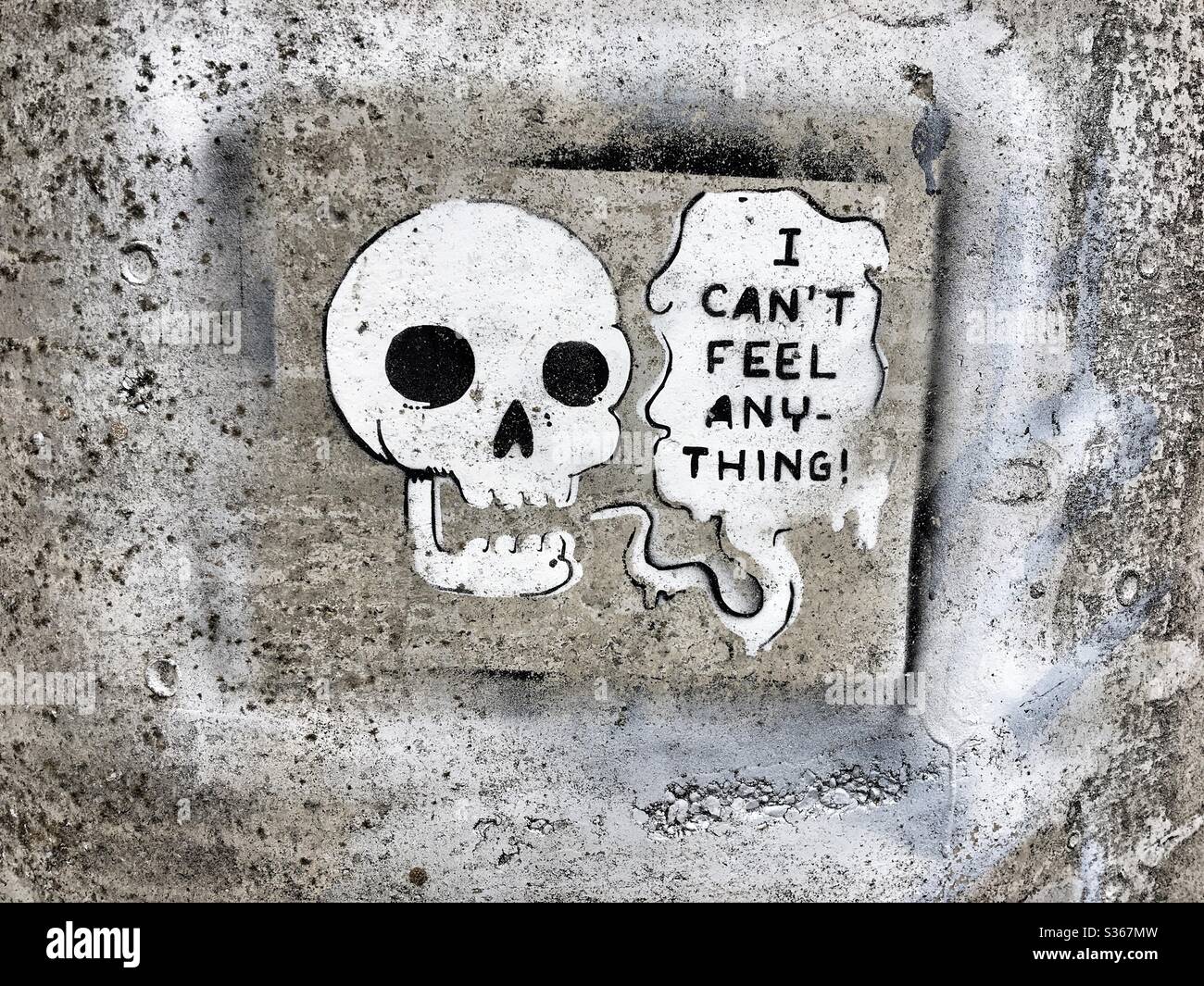 A stencil graffiti of a skull saying I cant feel anything Stock Photo ...