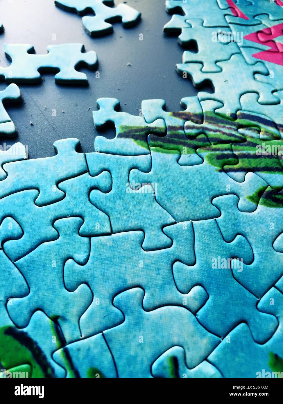 Jigsaw puzzle pieces in progress hi-res stock photography and images ...