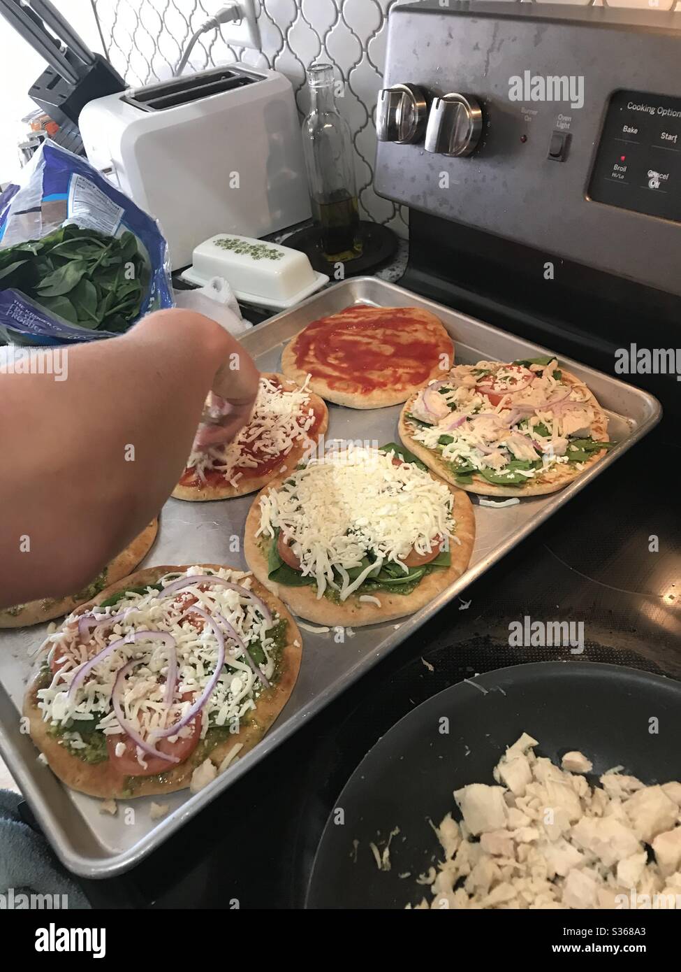 Making healthy individual pizzas Stock Photo - Alamy