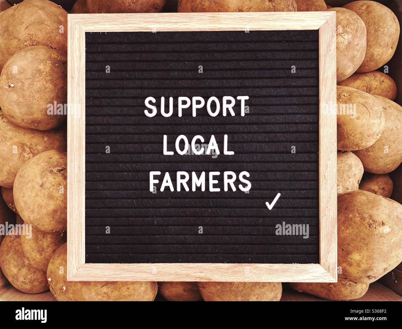 Support local farmers sign against a rustic background of fresh ...