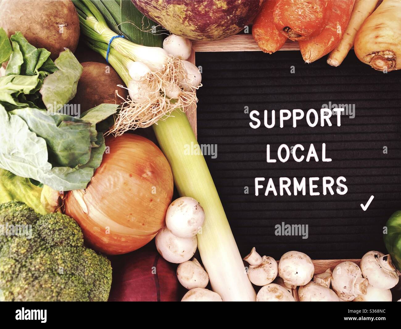 Support local farmers sign against a rustic background of of fresh ...