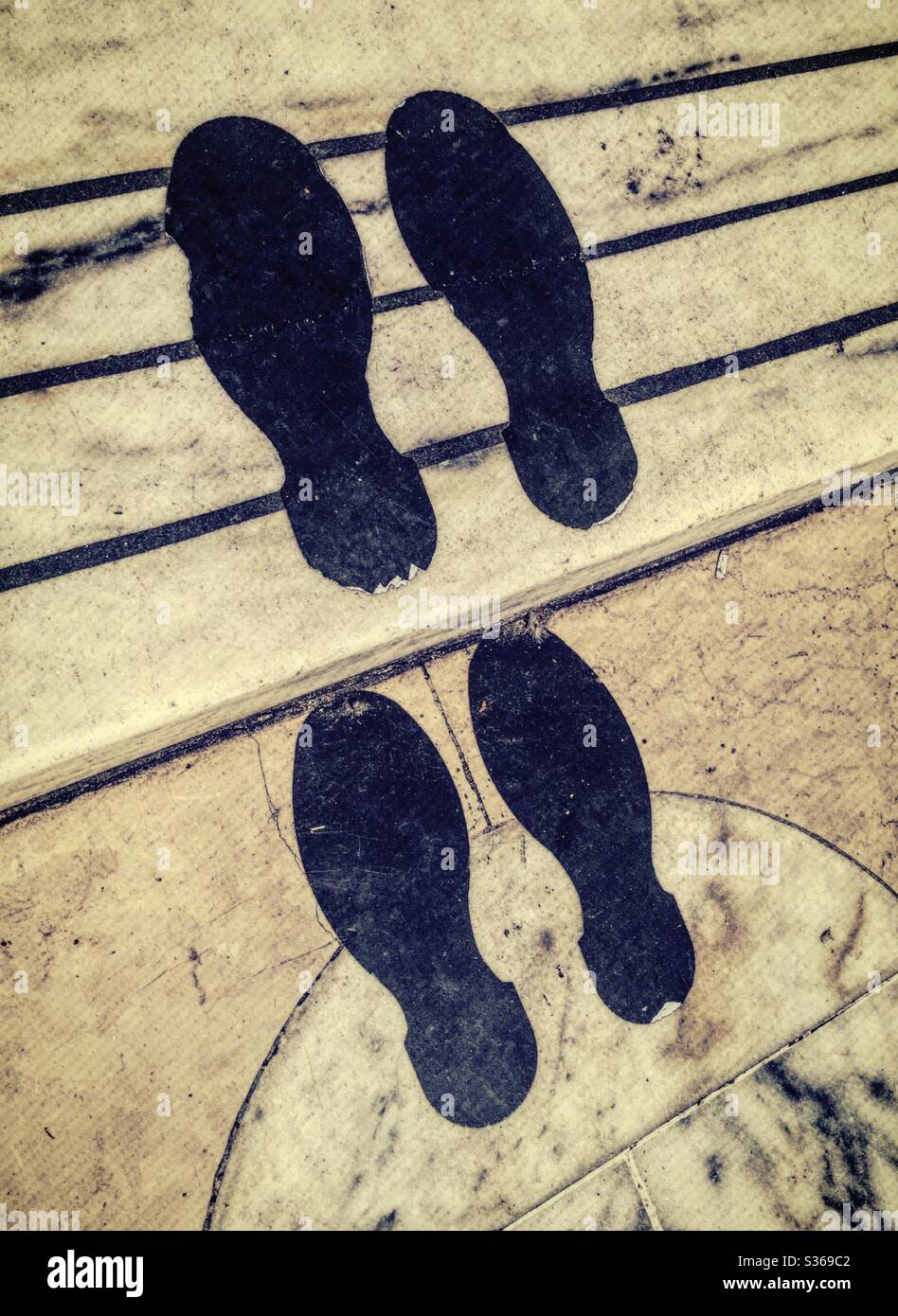 Two pair of Foot print stickers on marble steps Stock Photo - Alamy