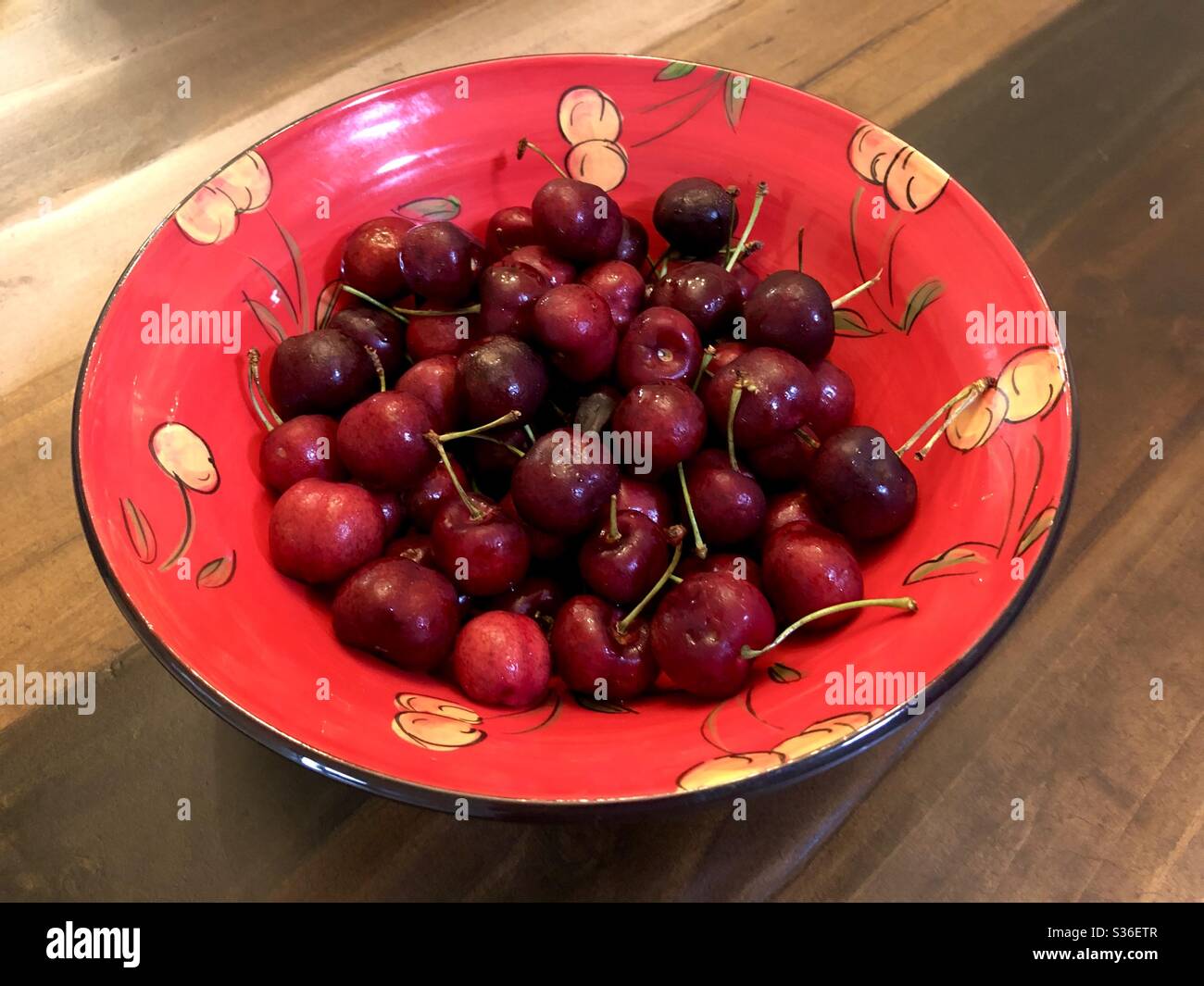 A bowl of red bing cherries in a cherry motif ceramic bowl Stock Photo ...