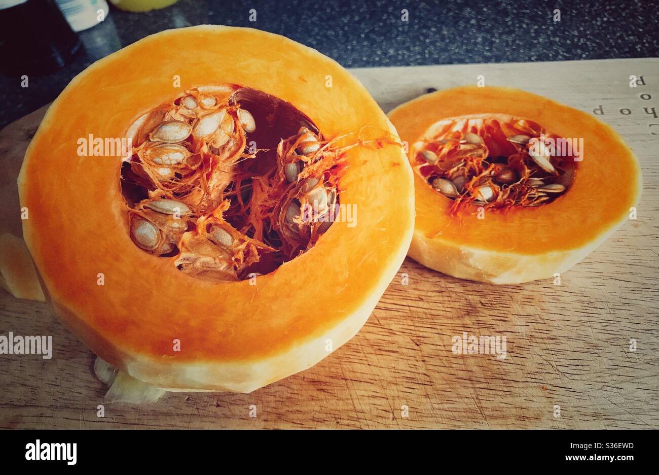 Butternut Squash cut open on a chopping Board Stock Photo - Alamy