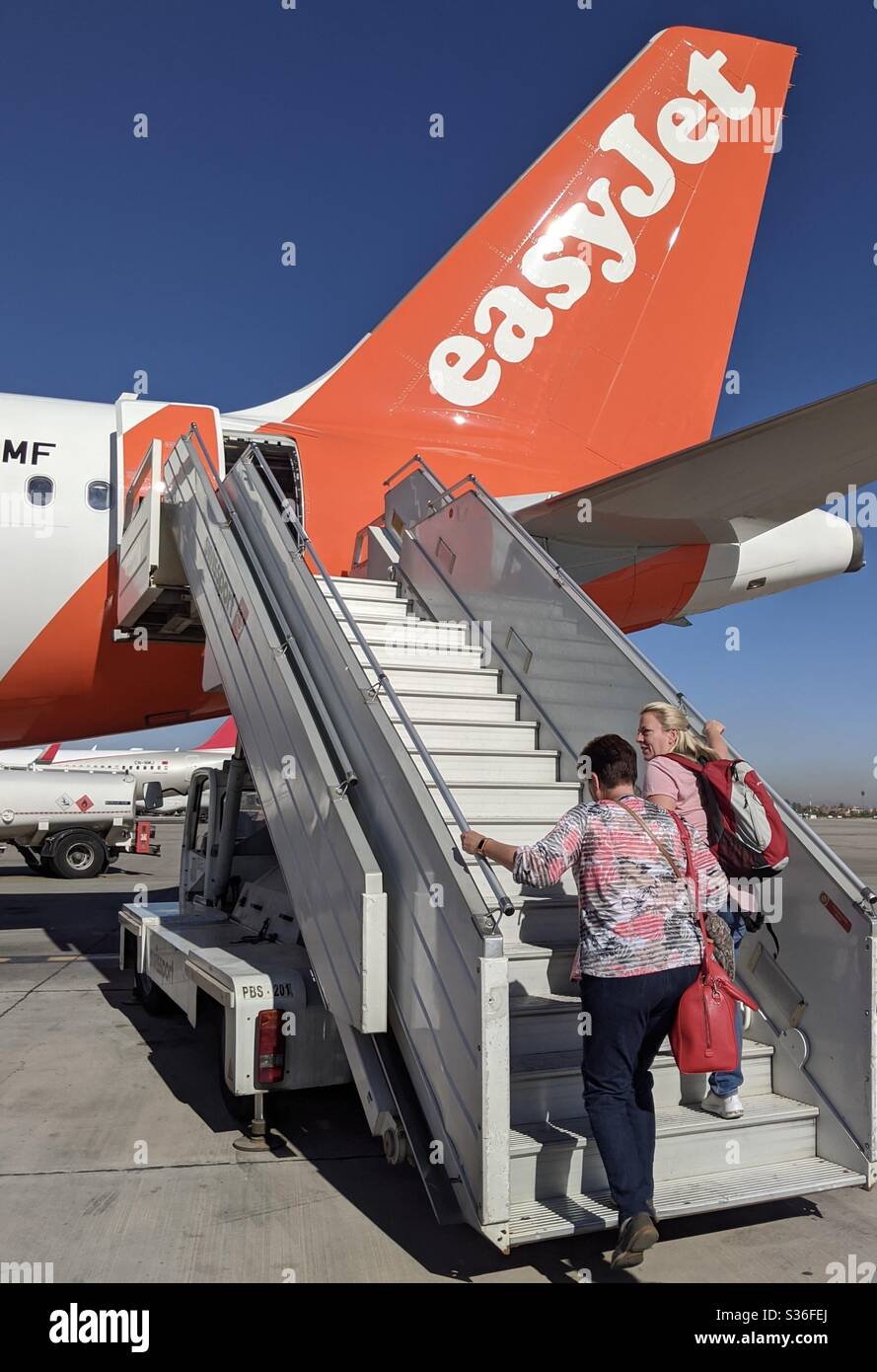 Woman boarding aeroplane hi-res stock photography and images - Alamy