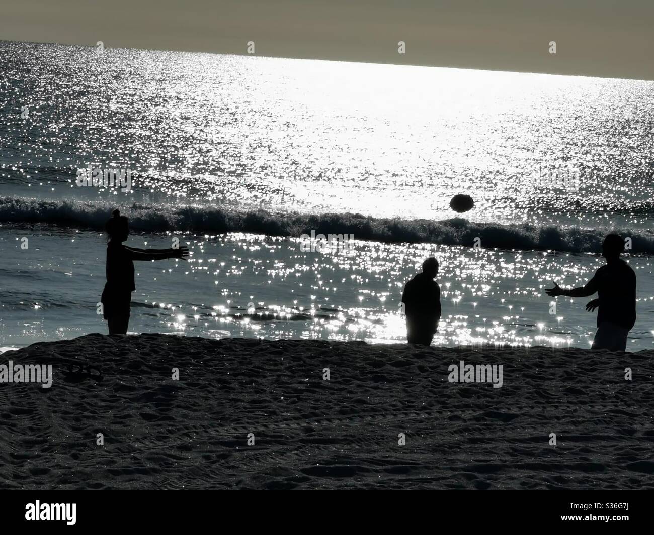 Family playing rugby on the beach Stock Photo - Alamy