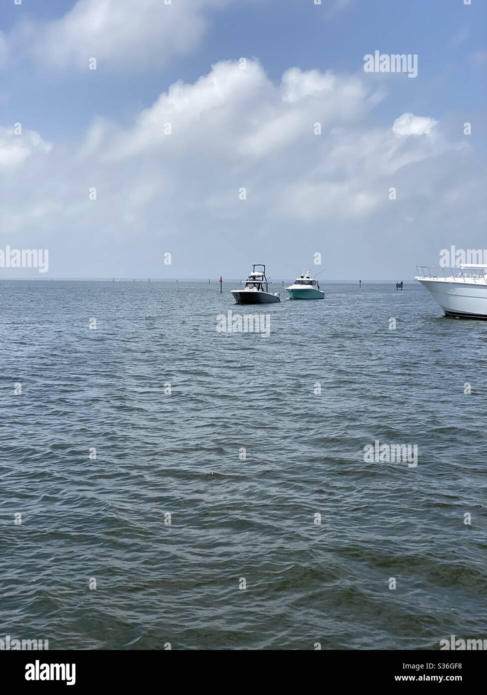 Boat being towed by another boat into the harbor Stock Photo - Alamy