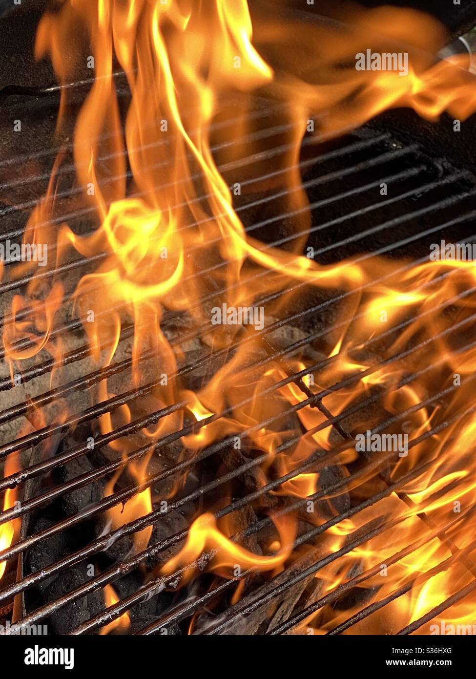 Fire on the grill Stock Photo - Alamy