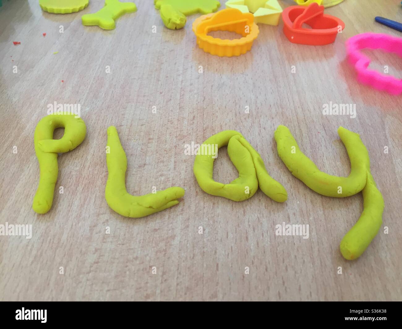 The word play made in yellow playdoh Stock Photo - Alamy