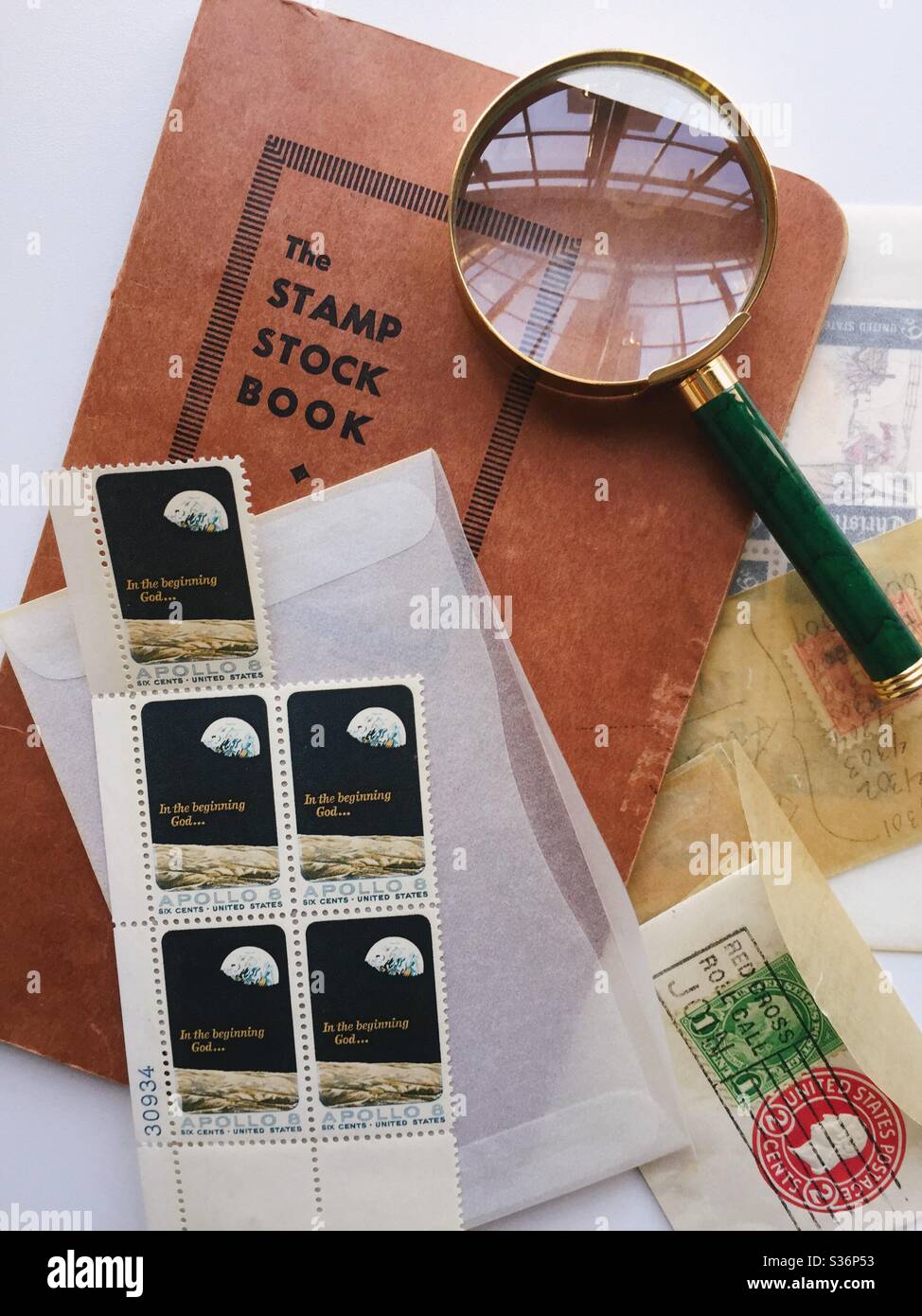 Still life of a stamp collectors stock book, plate block stamps and ...