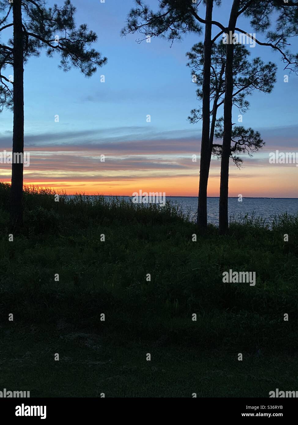 Sunset skies over Choctawhatchee Bay Florida in a preservation ...