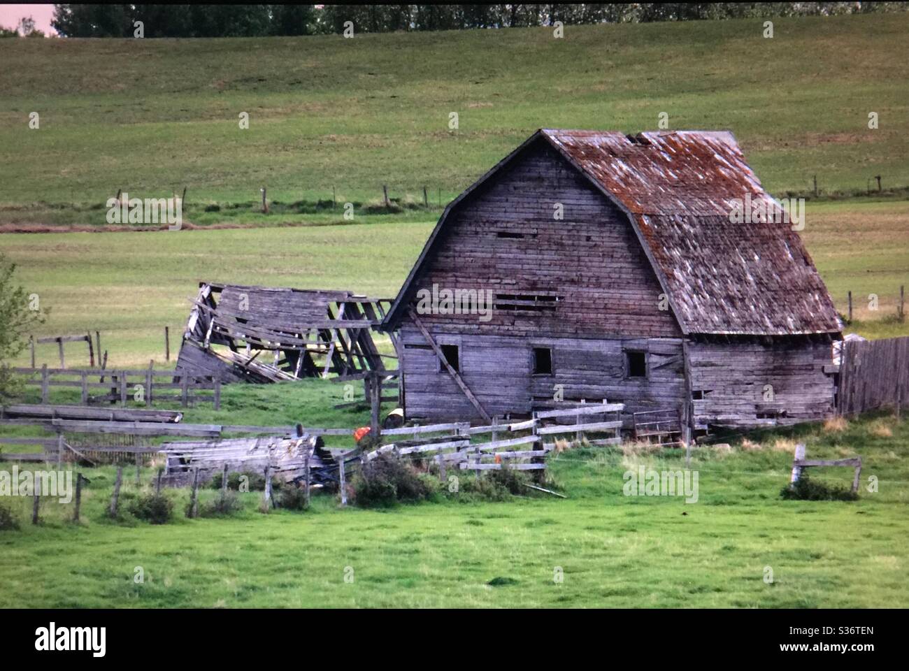 Old hip roofed barn, scenic surroundings , decaying and broken down ...