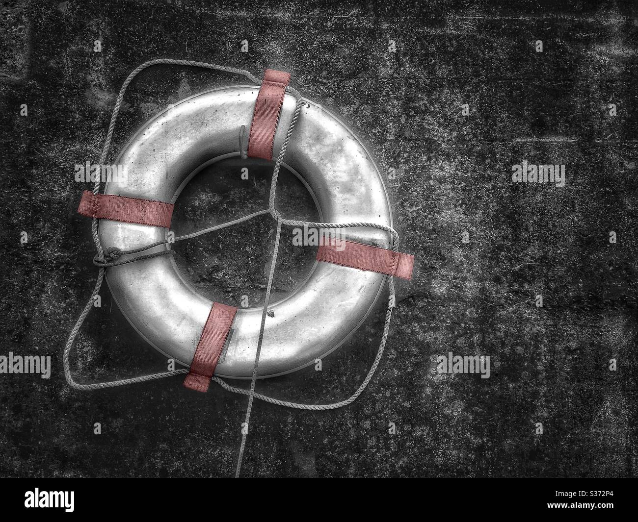 Life preserver ring attached to a weathered sea wall Stock Photo - Alamy