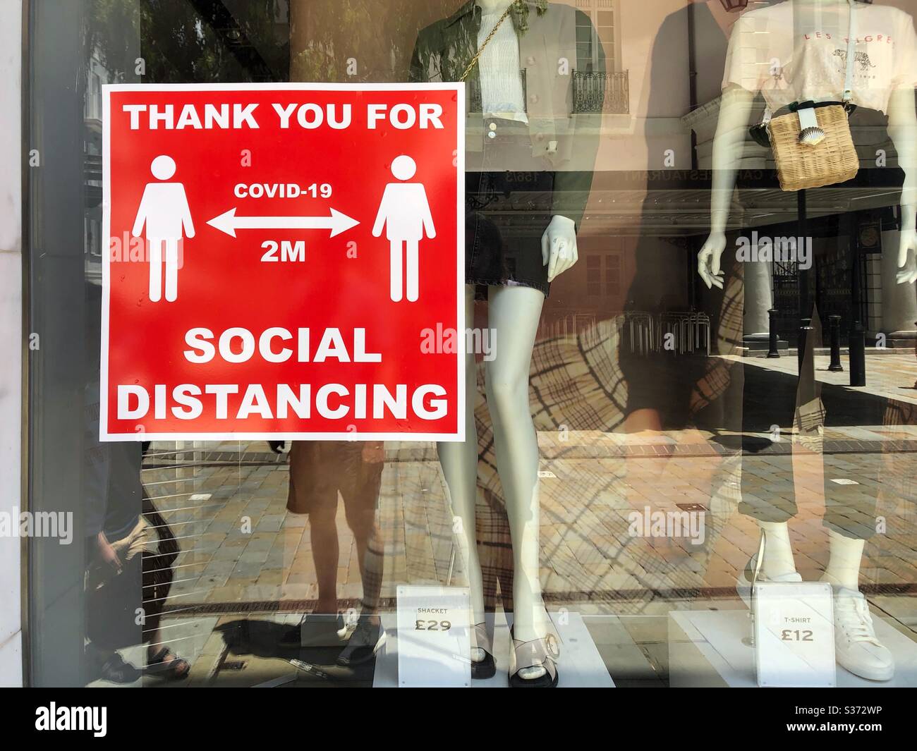 Social distancing sign in a shop window Stock Photo - Alamy