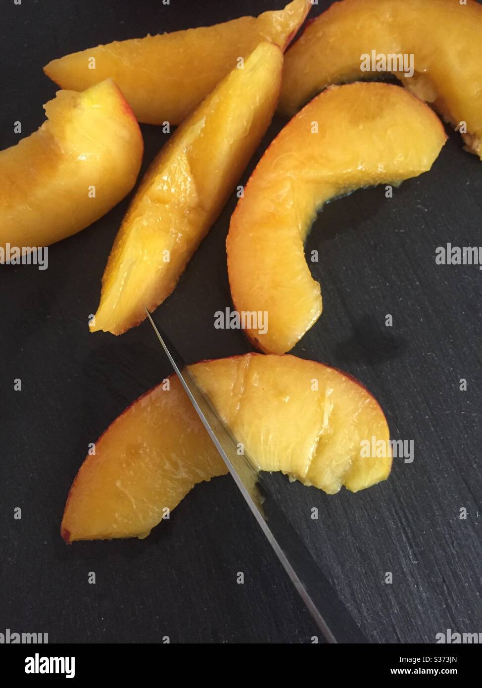 Cutting slice of nectarine Stock Photo - Alamy