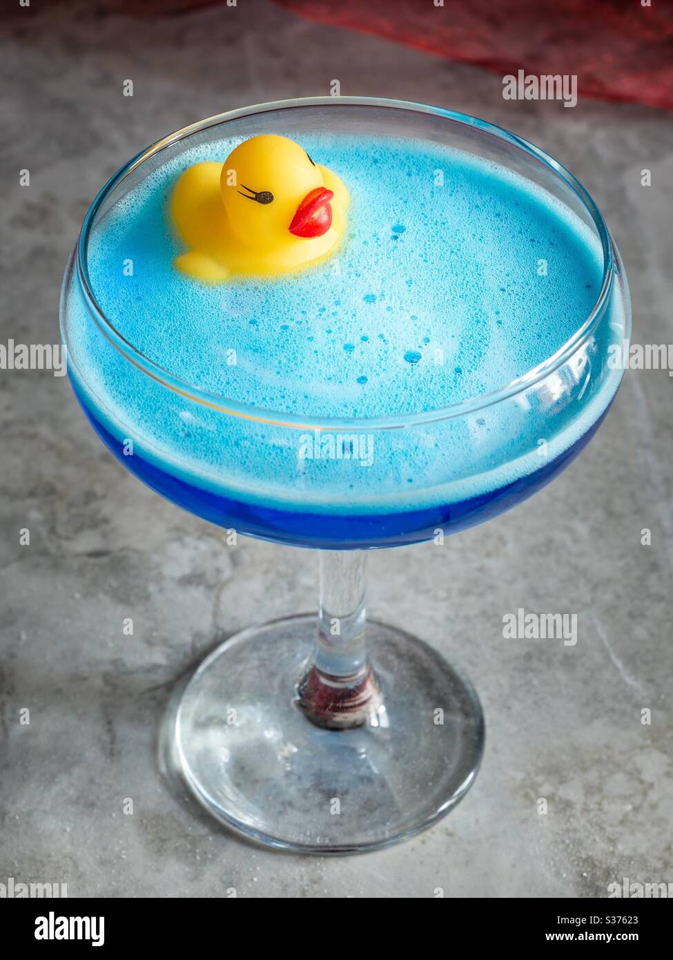 Yellow duck in a blue cocktail. Cute fun drink. Curaçao cocktail ...