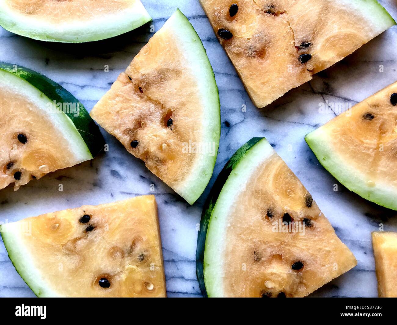 Yellow watermelon slices Stock Photo - Alamy