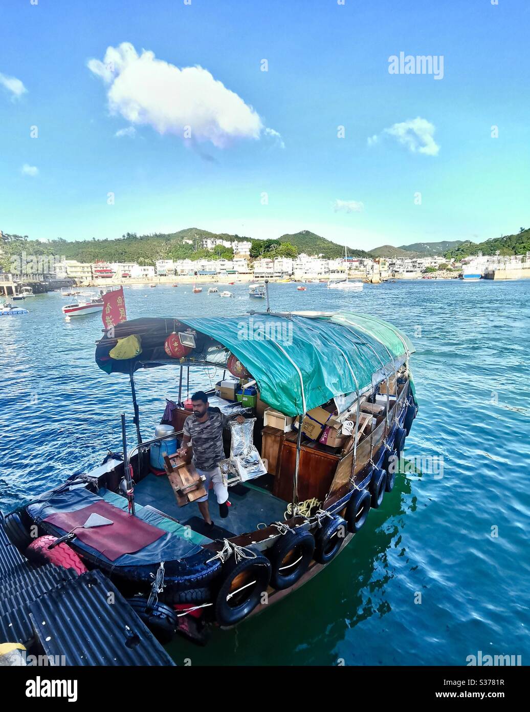 Transporting house content with a traditional Sampan boat in Hong Kong ...