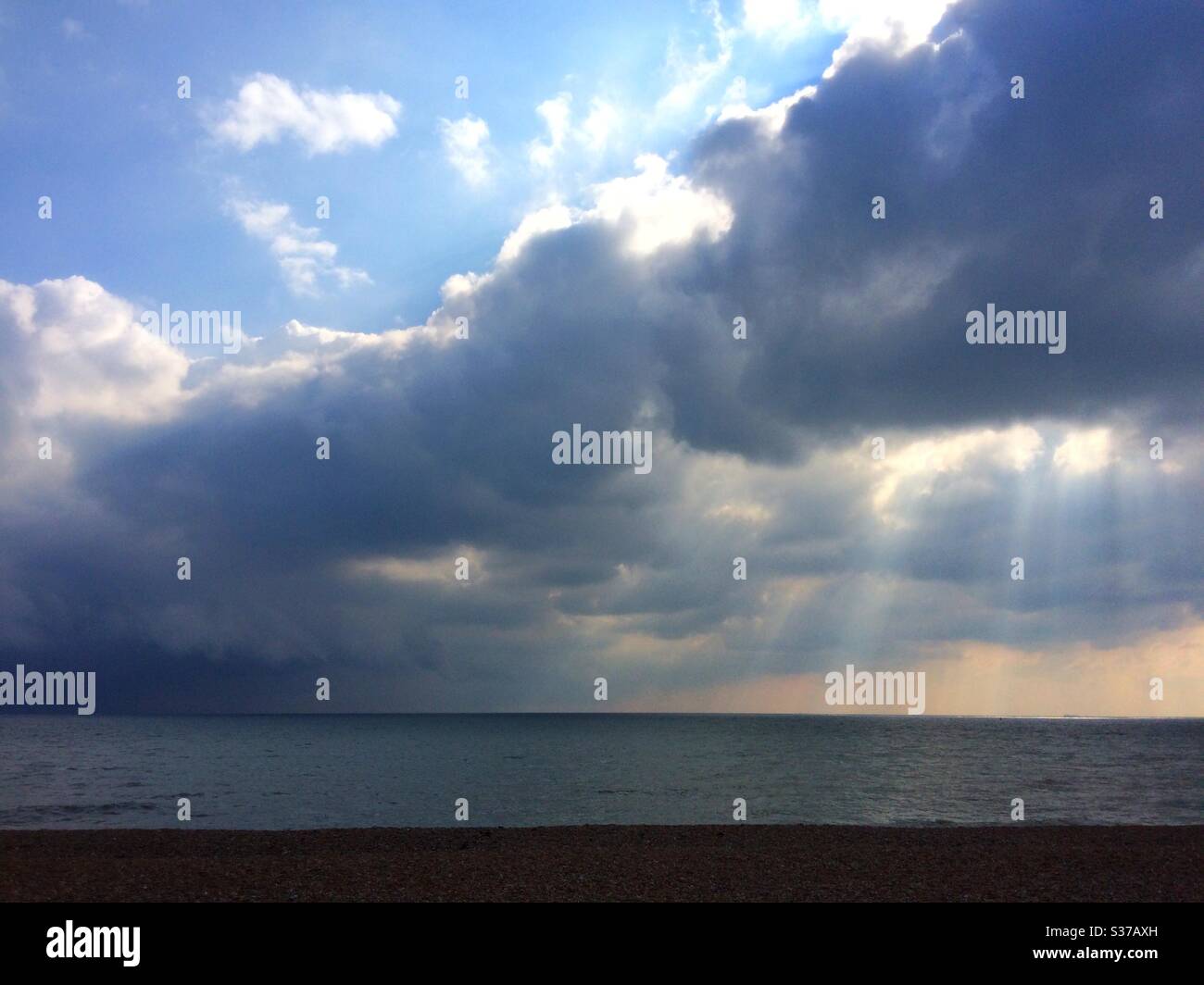 Rays of sunshine piercing through the clouds like God’s fingers over ...