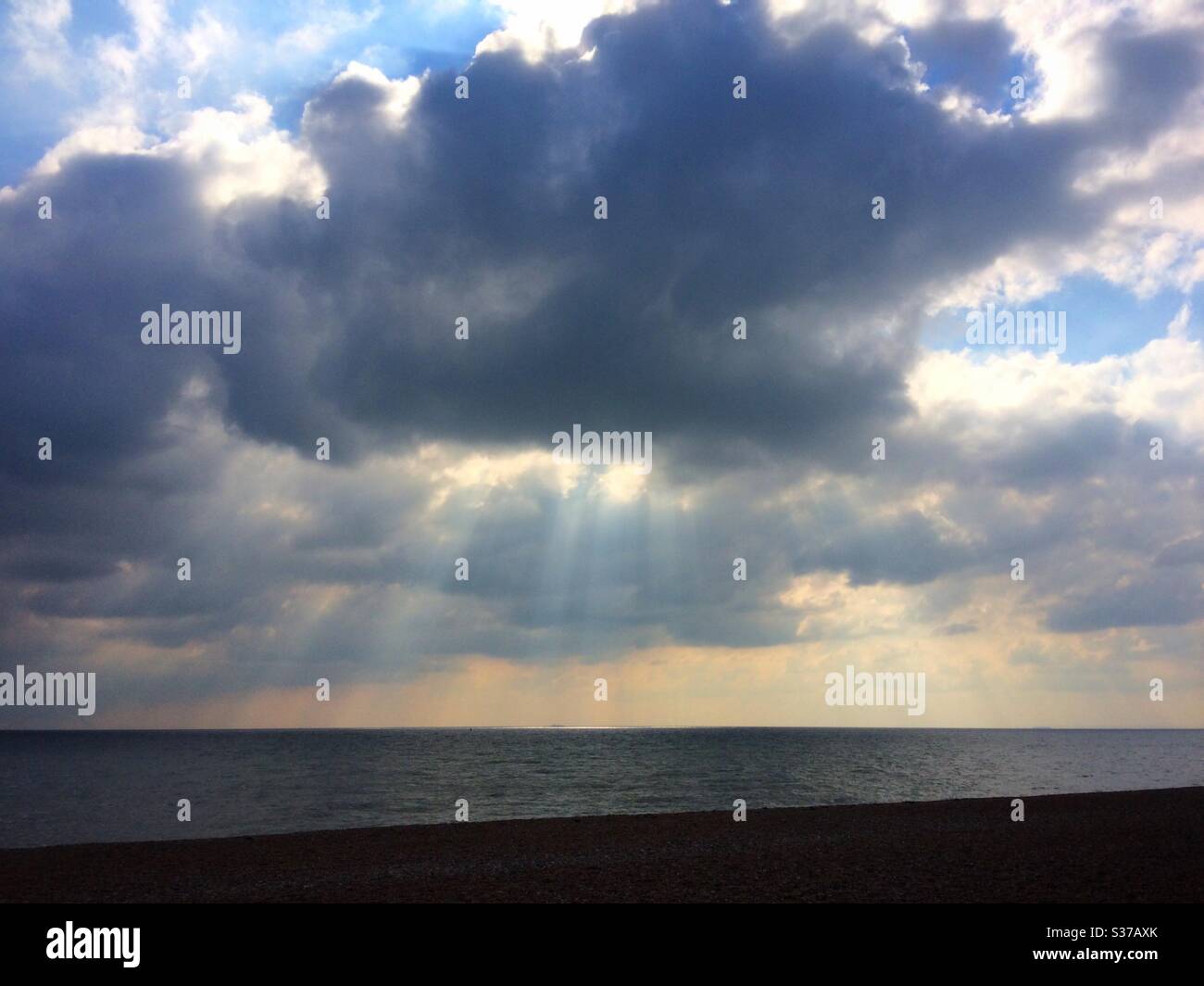 Sunshine piercing through the clouds like God’s fingers at the seaside ...