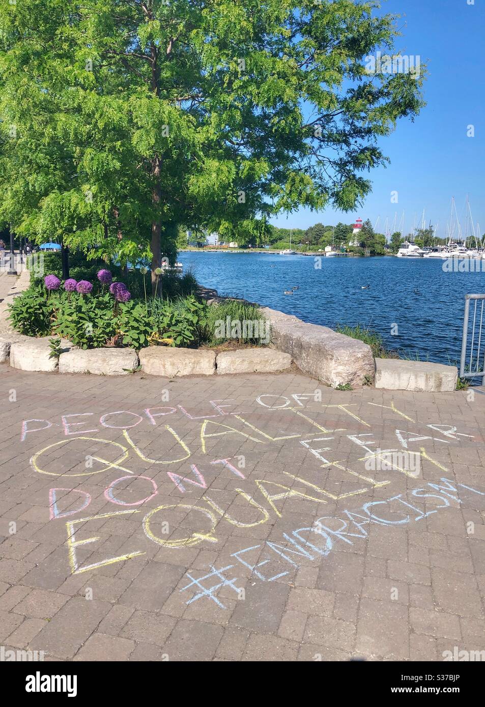 Chalk message written on the lakeside walkway - end racism Stock Photo ...