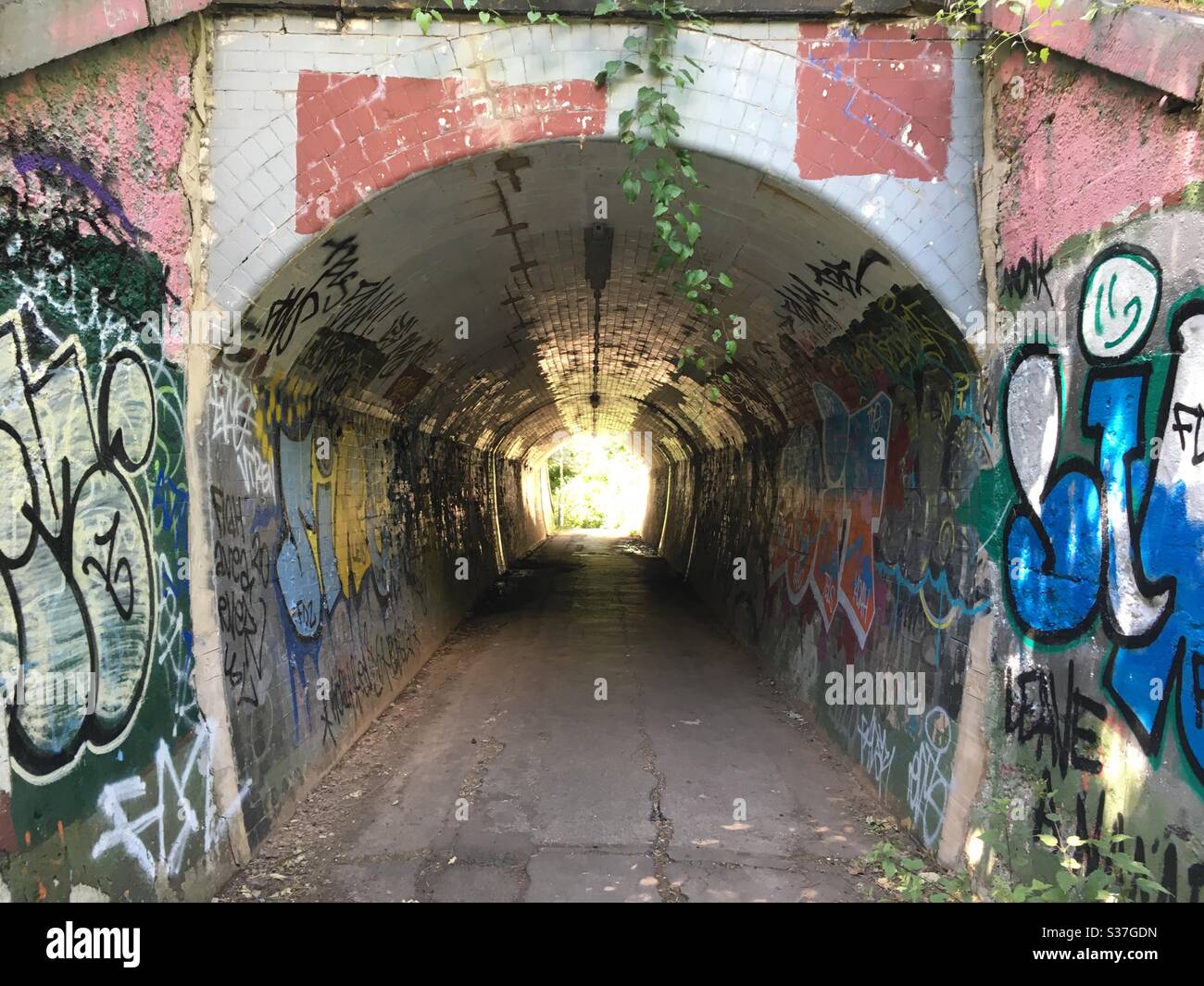 Graffiti on tunnel under railway Stock Photo - Alamy