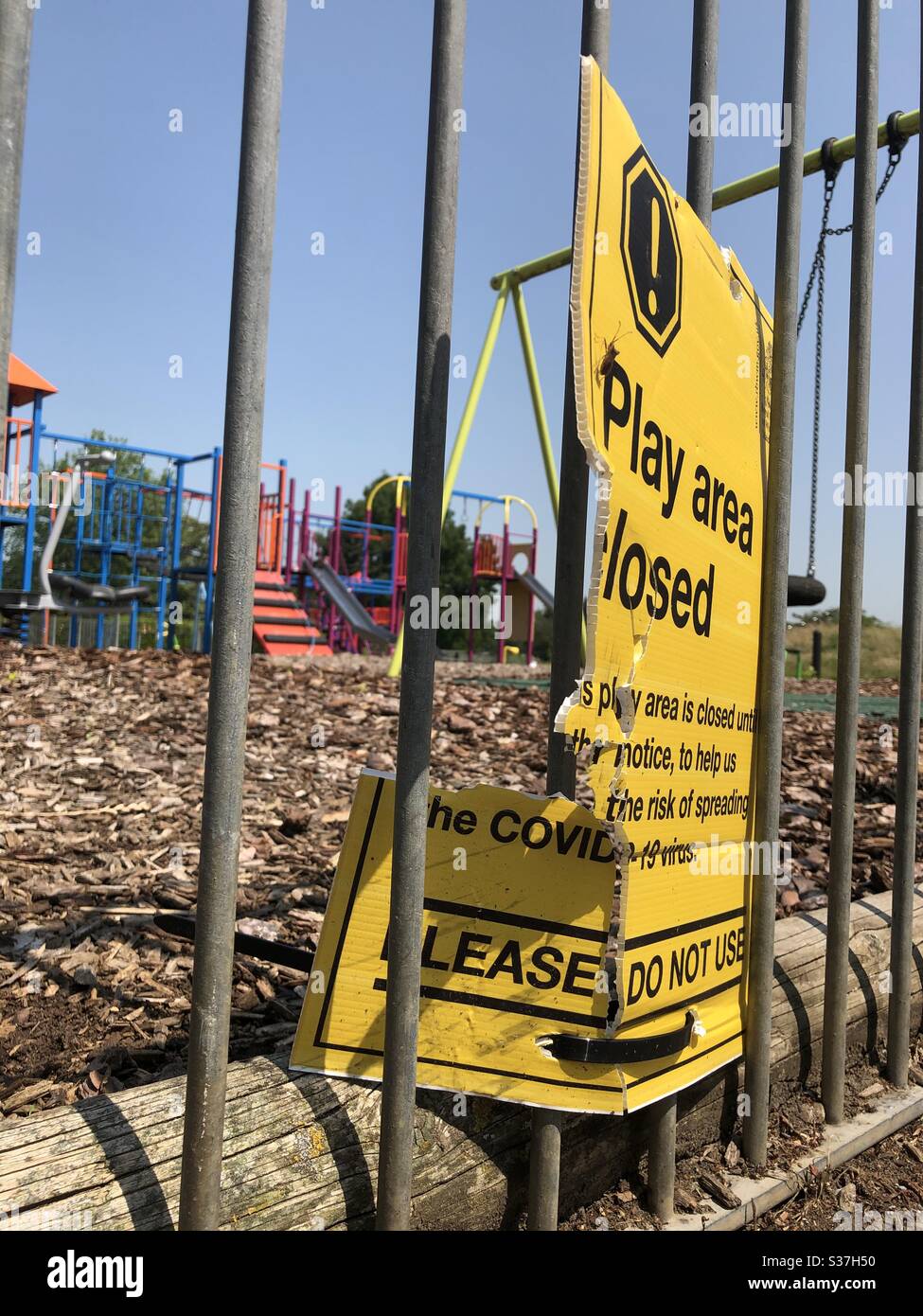 Play area closed due to coronavirus Covid 19 pandemic. Damaged sign ...