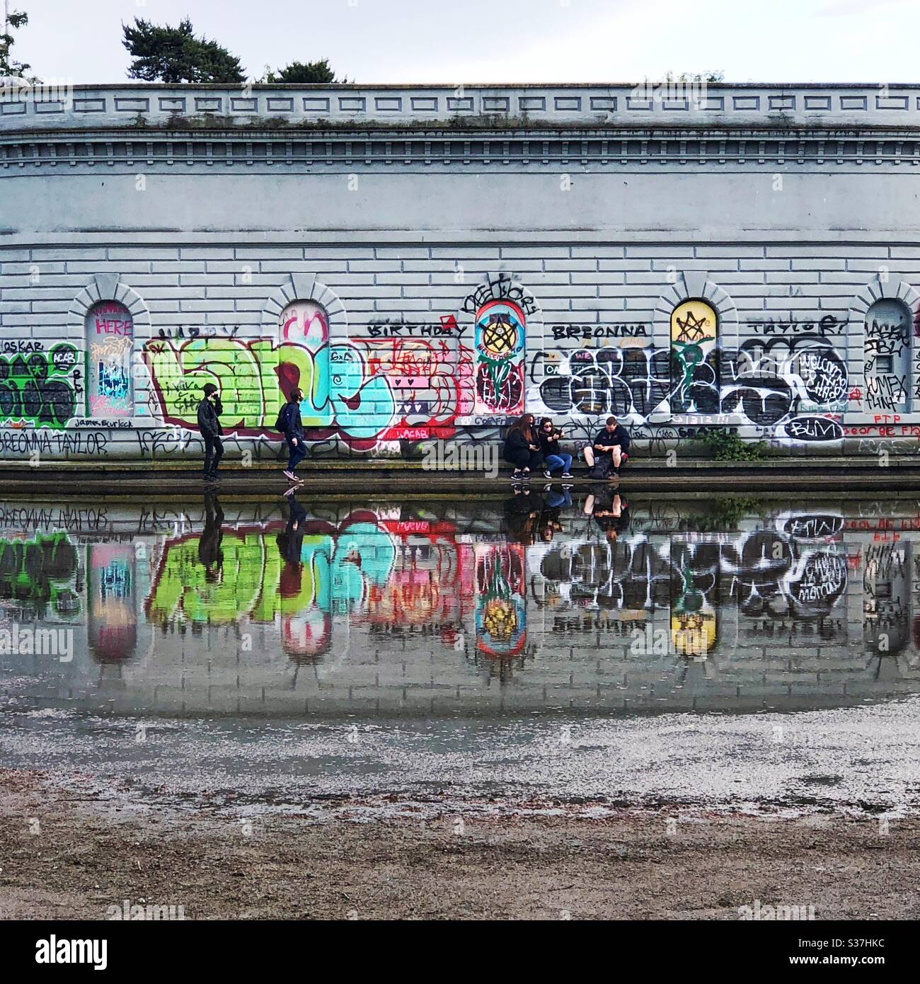 People walking and sitting at Old Pumphouse at Cal Andreson Park in ...