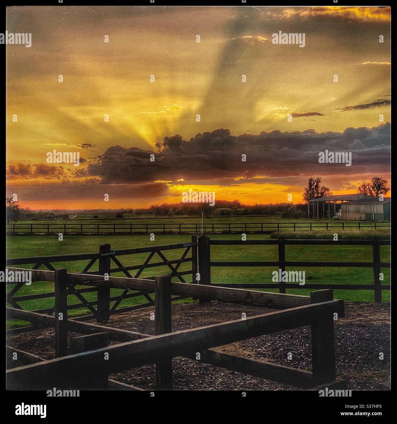 Farmyard Sunset - sun setting over a farmers field in Norfolk with ...