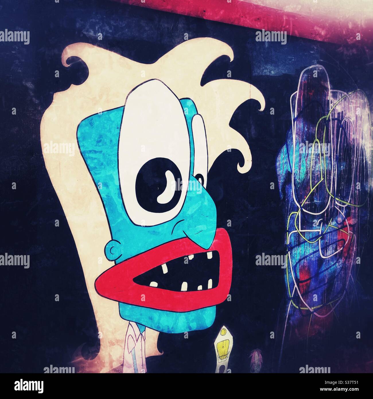 Crazy blue face street art graffiti on wall in Croydon in London Stock ...