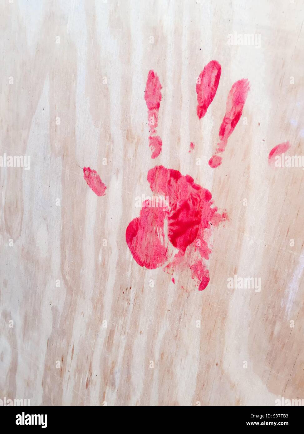 Hand print painted in red on a wooden wall Stock Photo - Alamy