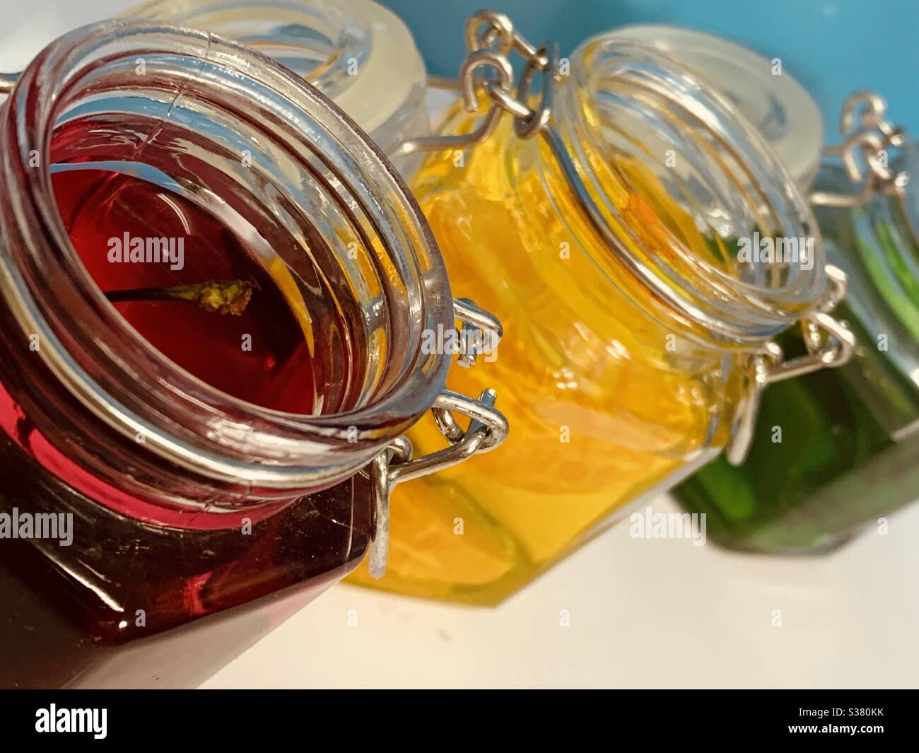Three jars filled with colored juice Stock Photo - Alamy