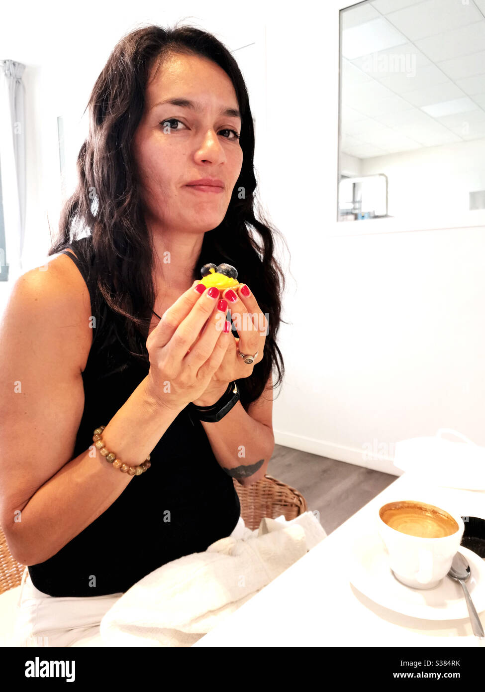 Young woman eating sweet puff Stock Photo - Alamy