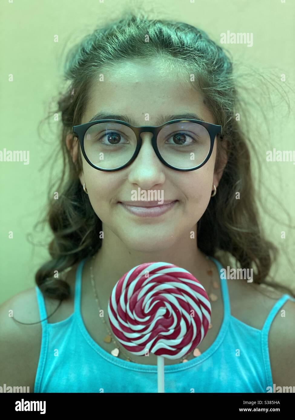Teen portrait with a red and white candy Stock Photo - Alamy